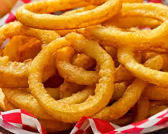 Golden, crispy perfection in circular form. These onion rings aren't just a side dish &ndash; they're the main event.