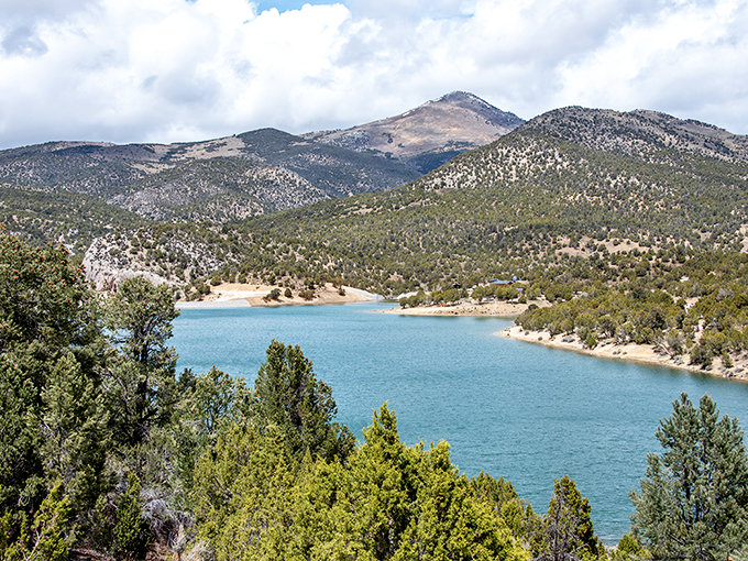 The view that launched a thousand desktop backgrounds. Cave Lake's waters shift between Caribbean blue and emerald depending on the sky's mood.