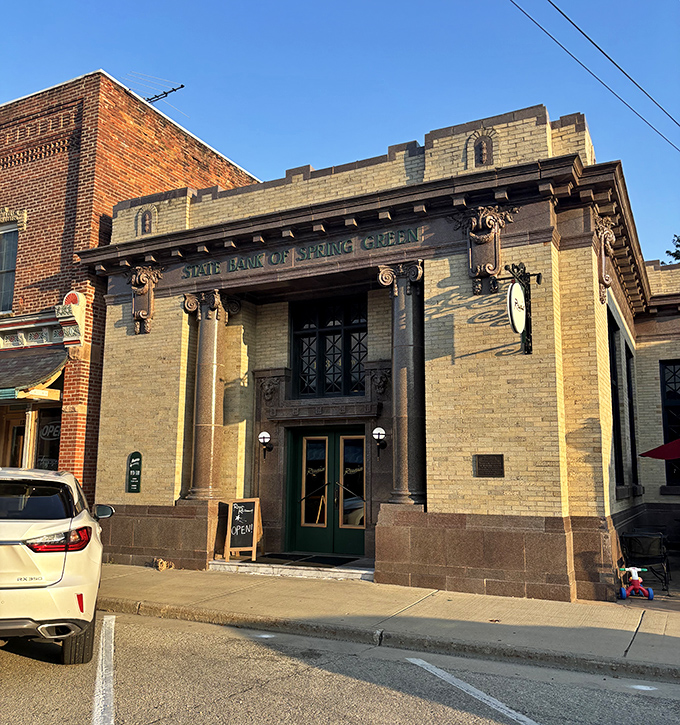 The former State Bank building now houses stories instead of safety deposit boxes, its architectural details whispering tales of bygone prosperity.