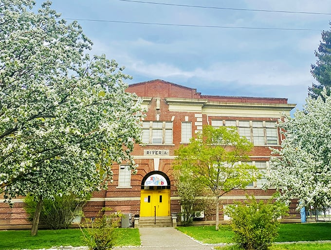The Riveria Activity Center stands proudly among spring blossoms, its bright yellow doors practically shouting "Come in and play!" to passersby.