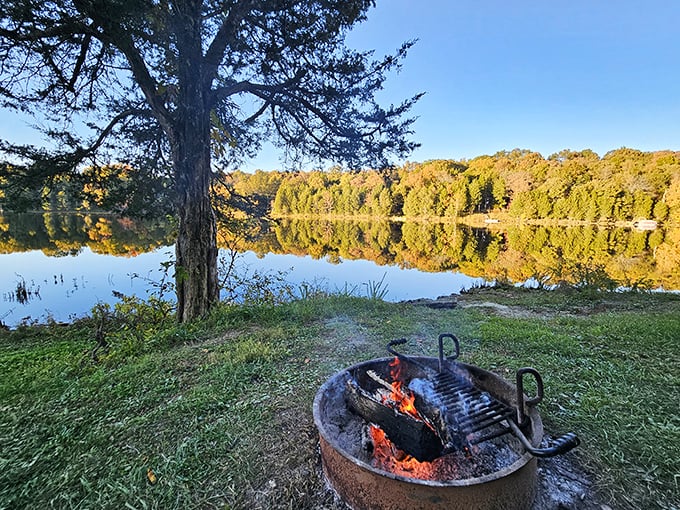 Fall camping perfection: a crackling fire, mirror-like water reflections, and that magical moment when nature outperforms any filter you could possibly apply.