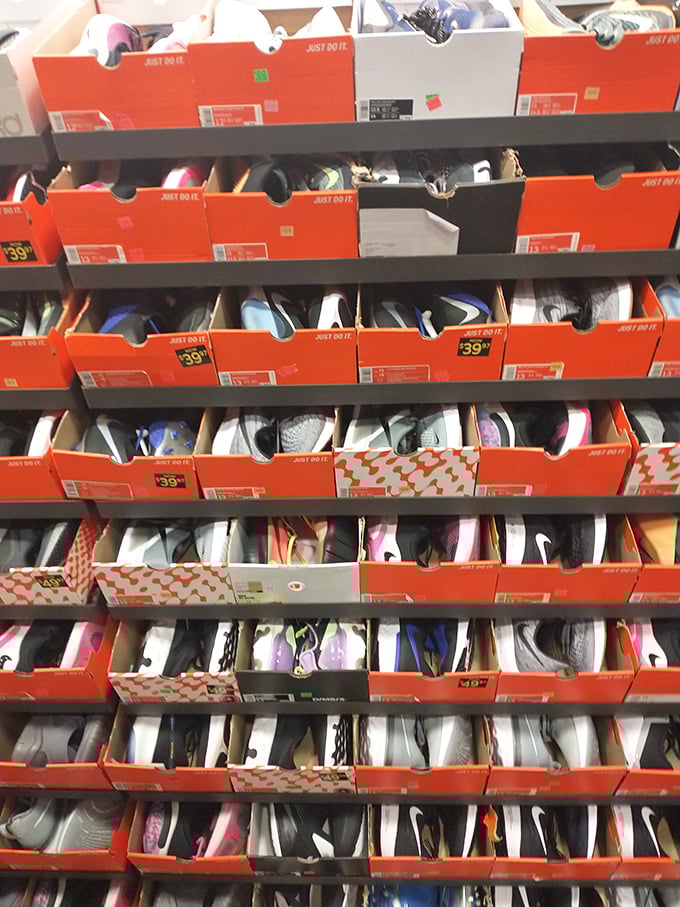 Nike's orange boxes stacked like a monument to athletic aspiration. Each one contains not just shoes, but the possibility of becoming your better self&mdash;at 40% off.