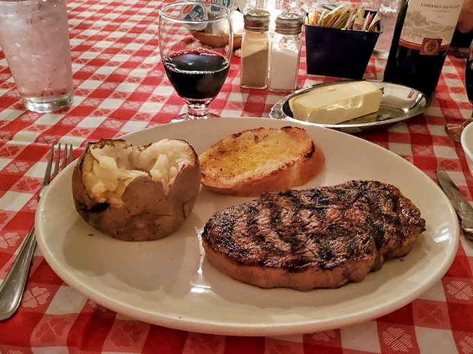 The star of the show in all its glory. A perfectly seared ribeye alongside a fluffy baked potato and golden Texas toast &ndash; the holy trinity of steakhouse perfection.