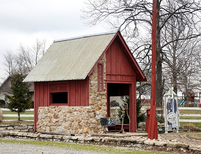 This charming stone and wood structure provides perfect rustic context for the mammoth farm tool looming nearby.