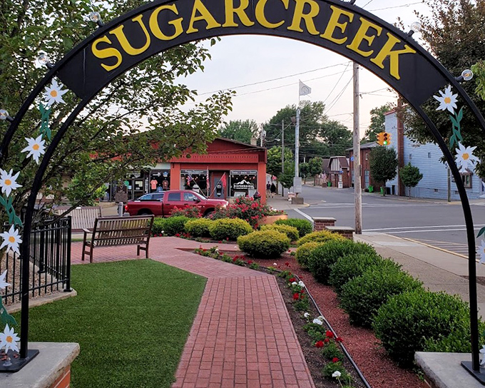 The Sugarcreek archway welcomes visitors with daisy decorations and small-town charm, like stepping into a Hallmark movie without the predictable plot.