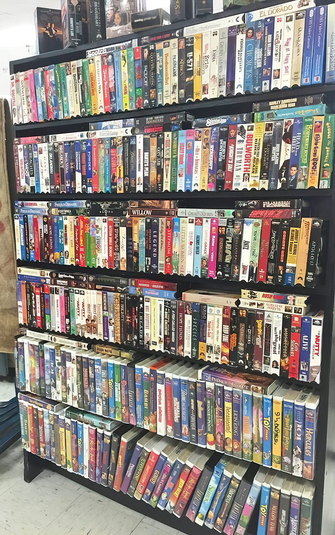 VHS paradise! A wall of nostalgia where "Be Kind, Rewind" isn't just a suggestion but a trip back to simpler entertainment times.