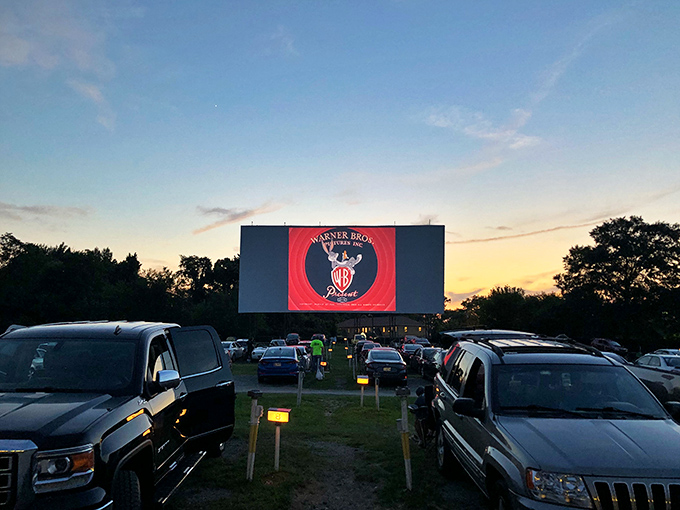 Warner Bros' iconic logo commands attention on America's largest movie screen. From this angle, every car has the best seat in the house—because they're all houses.