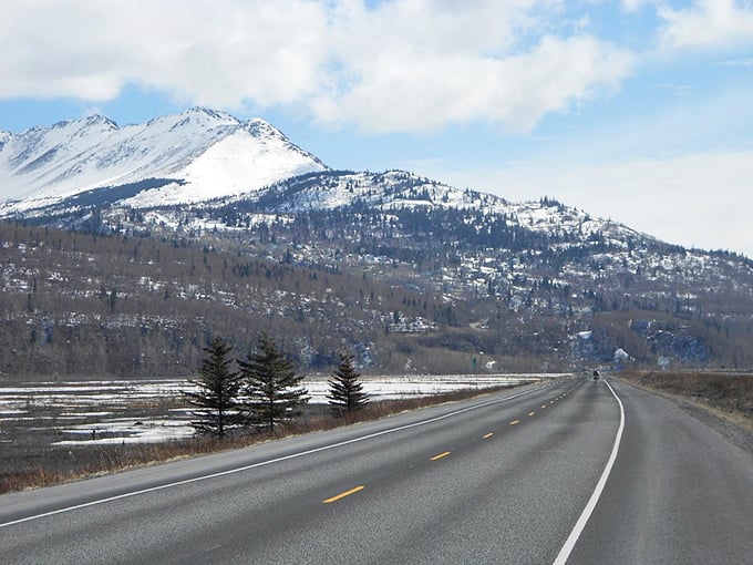 The road to adventure unfolds with mountains standing guard. That moment when your commute suddenly becomes the highlight of your day.