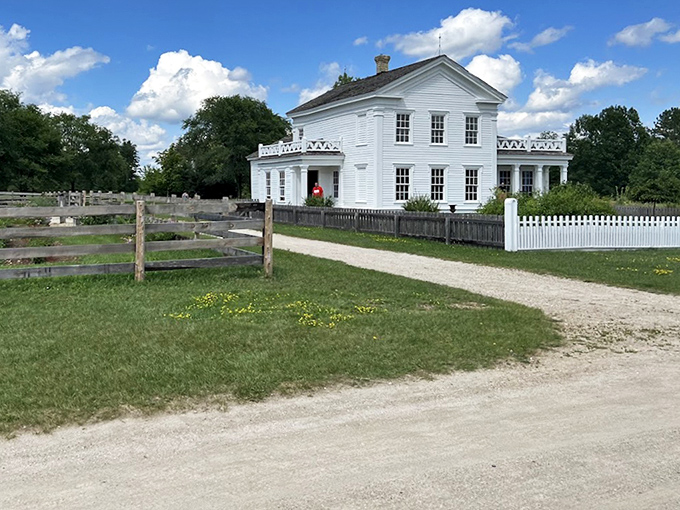 This stately white farmhouse isn't just photogenic&mdash;it's architectural time travel with its perfect symmetry and wraparound porch whispering tales of Sunday socials.