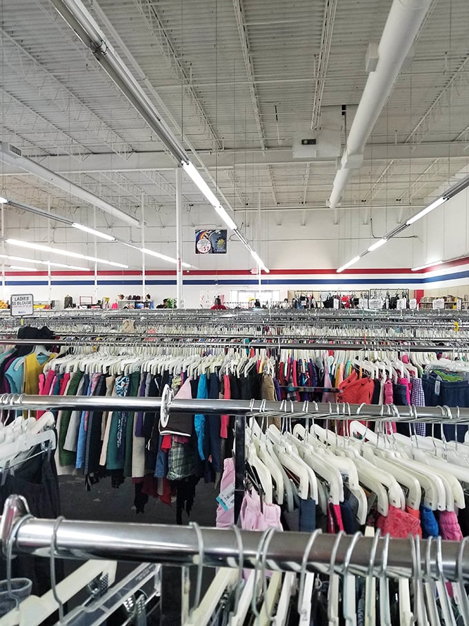 Endless racks stretch toward retail infinity, a textile galaxy where each hanger holds a story waiting to be continued.