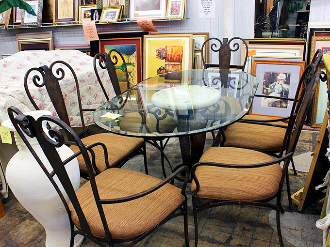Wrought iron elegance meets secondhand affordability. This glass-topped dining set waits patiently for someone to recognize its potential as tomorrow's dinner party centerpiece.