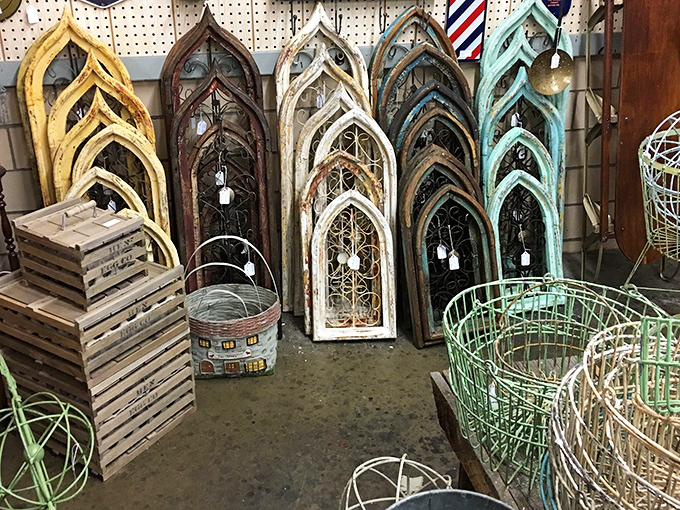 Gothic-inspired architectural frames lean like old friends sharing stories, their weathered finishes ranging from sunshine yellow to seafoam green.