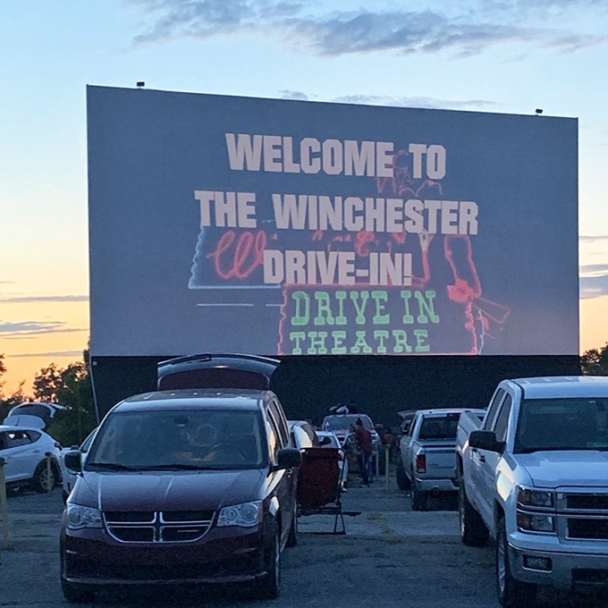 "Welcome to the Winchester Drive-In!" The greeting glows against the twilight sky, promising an evening where memories are made between car doors.