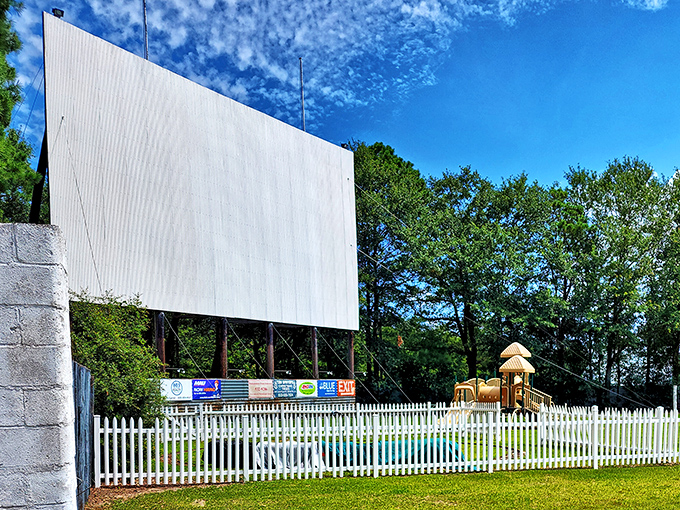 Beyond the white picket fence, a playground and that iconic screen stand ready for the perfect family double feature.