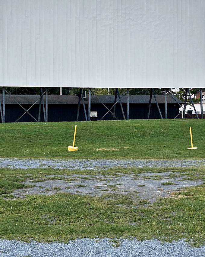 The big screen looms large against the sky, where stories come alive after sunset.