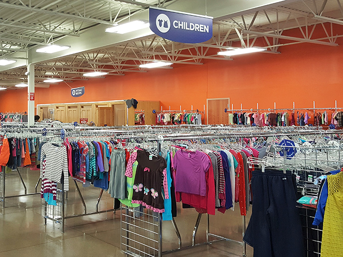 The children's section pops with vibrant orange walls and rainbow-arranged clothing. Parents rejoice: growing kids and shrinking wallets have finally found their happy place.