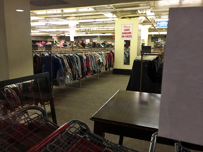 "Please leave hangers on racks" signs remind us we're in a place where order somehow emerges from the beautiful chaos of secondhand abundance.