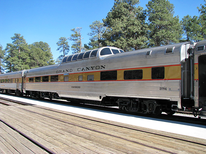 The silver Coconino observation car gleams in the Arizona sunshine. Those dome windows promise panoramic views that no smartphone screen could ever replicate. 