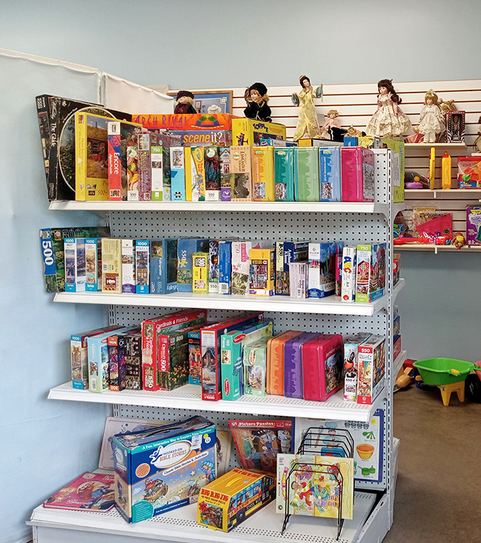 Board game heaven! Vintage puzzles and games stack neatly alongside collectible dolls, promising hours of nostalgic entertainment.