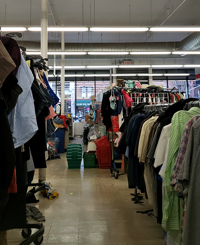 Inside awaits a fluorescent-lit wonderland where clothing racks stretch like an urban forest. The thrill of the hunt begins here.