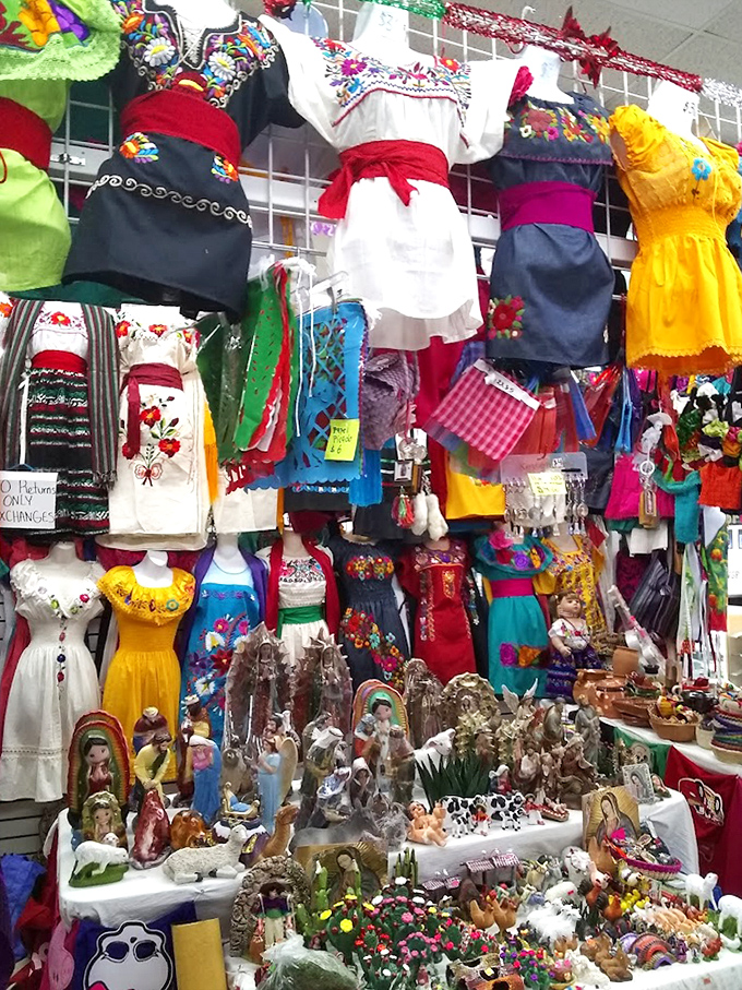 A kaleidoscope of traditional Mexican dresses creates a vertical rainbow. Each embroidered masterpiece tells stories through thread and color.