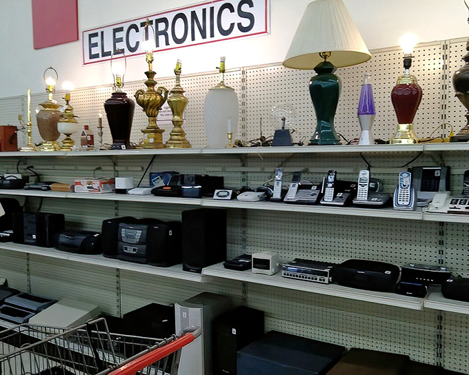The electronics section: where yesterday's cutting-edge technology finds new purpose, and vintage lamps stand guard over cordless phones from another era.
