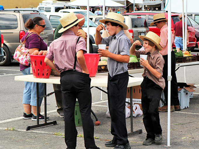 Young Amish men enjoying refreshments at the farmers market. Some traditions evolve while preserving what matters most&mdash;community and good food.