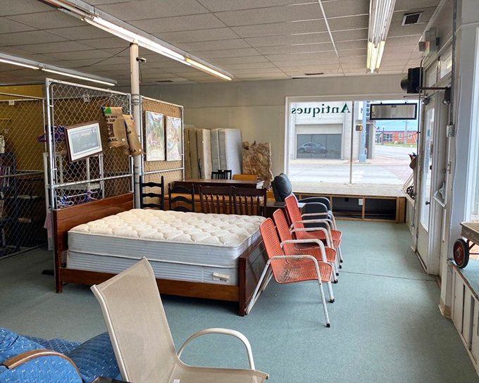 The practical meets the whimsical in this corner display, where vintage bed frames and retro orange chairs create a time-travel experience for shoppers.