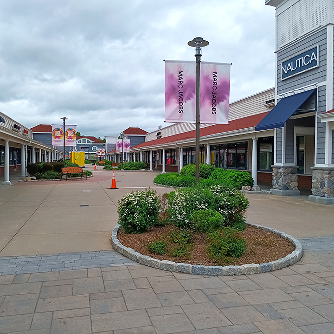 Wide walkways and colorful banners create a shopping village that feels more like a stroll through a friendly neighborhood.