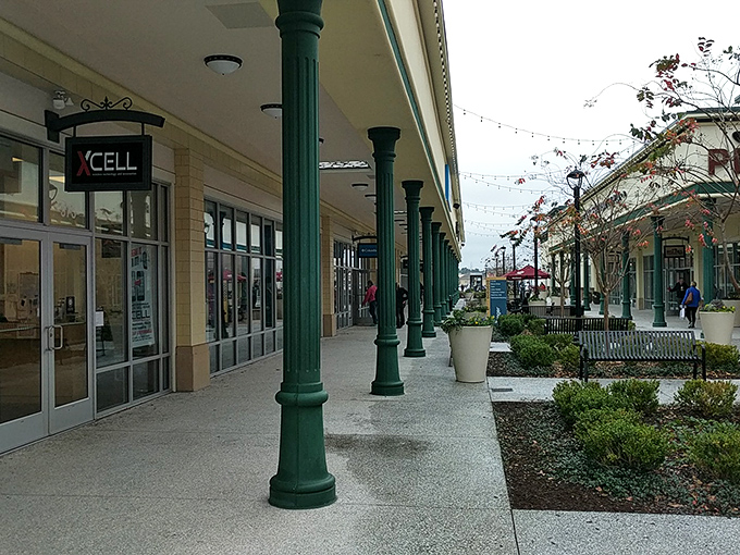 Green columns line the walkways like sentinels guarding the path to discount paradise. Your wallet's last line of defense.