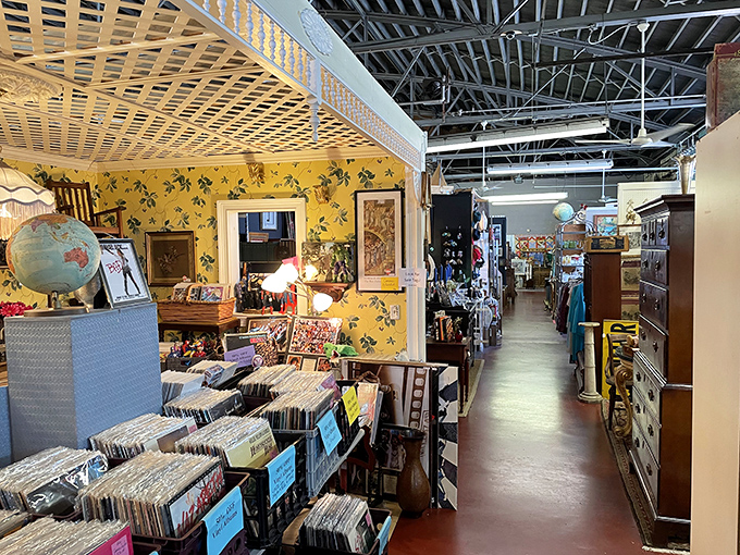Step into this yellow-wallpapered wonderland where vinyl records meet vintage furniture. The exposed beams above watch over decades of American craftsmanship below.