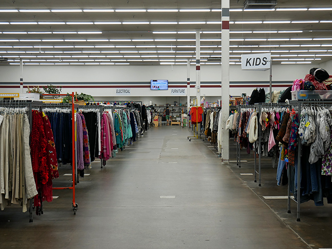 Color-coded clothing creates a rainbow roadmap through the women's section, where organization transforms chaos into a shopper's paradise.
