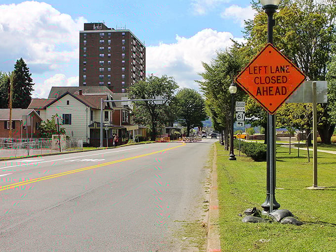 A residential street with apartment buildings and modest homes showcases the variety of affordable housing options that make Sunbury accessible on fixed incomes.