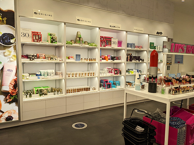 The Cosmetics Company Store beckons beauty enthusiasts down covered walkways where luxury brands meet outlet prices in air-conditioned bliss.