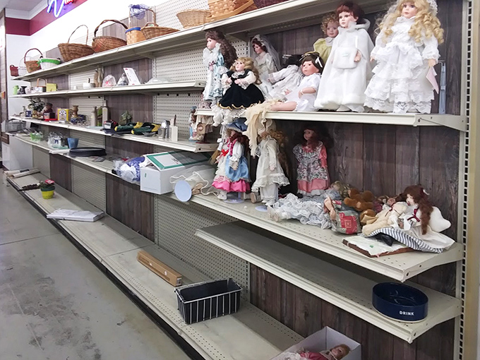 The doll section: where porcelain faces from bygone eras silently judge your fashion choices while offering themselves at bargain prices.