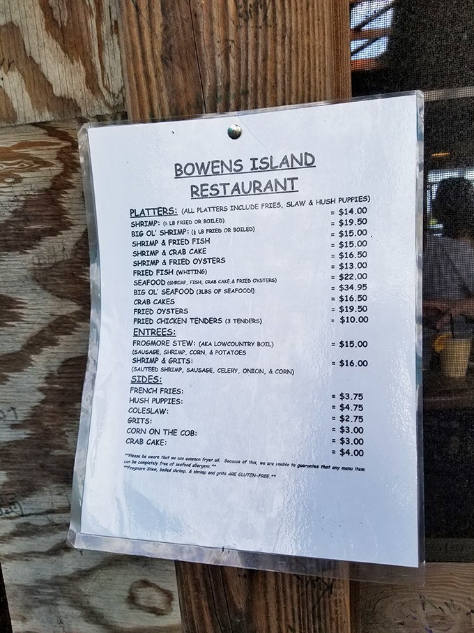 A menu taped to wood planks—the culinary equivalent of a treasure map. X marks the spot where Frogmore Stew meets your taste buds.