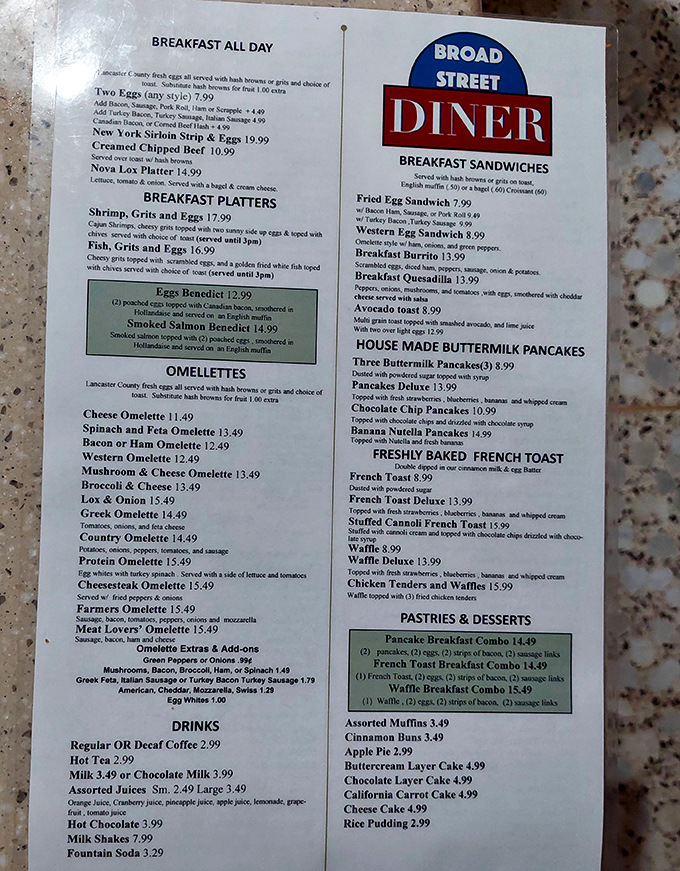 The menu – a laminated roadmap to happiness. Notice the Eggs Benedict highlighted in green, like a culinary treasure waiting to be discovered.