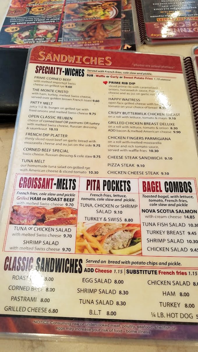 The menu reads like a comfort food encyclopedia. Each laminated page offers a portal to satisfaction, whether you're team breakfast or team sandwich.