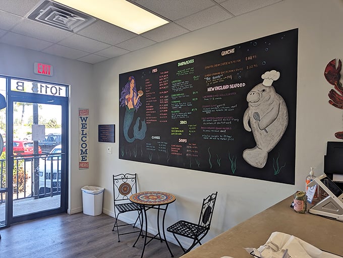 A chalkboard menu that reads like a love letter to New England seafood. The mermaid and manatee illustrations aren't just cute&mdash;they're prophetic.