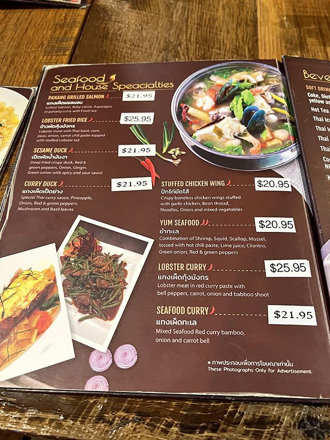 The menu reads like a love letter to Thai cuisine. Those little chili pepper symbols aren't just decoration&mdash;they're fair warning for your taste buds.
