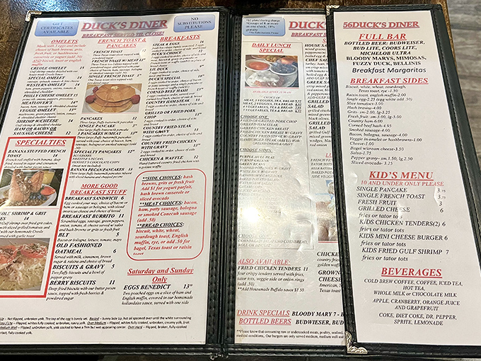 The menu at Duck's is a laminated love letter to breakfast classics. Reading it feels like planning a delicious adventure where every choice is the right one.