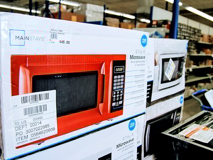 Brand new microwaves lined up like eager contestants on a game show, waiting for someone to take them home at a fraction of retail price.