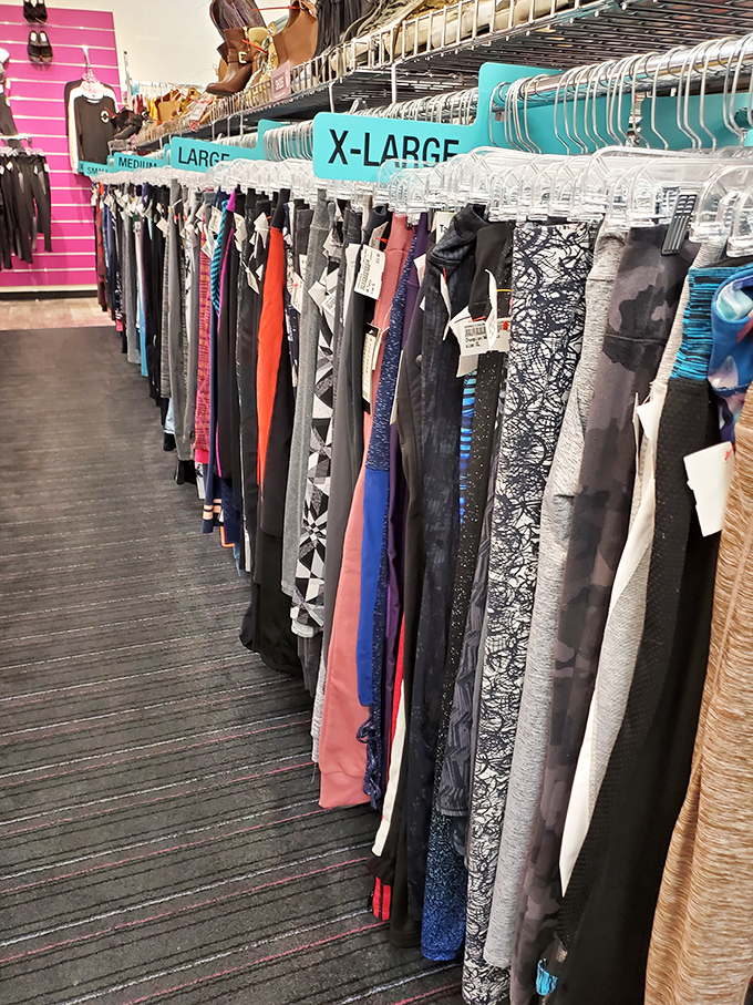 A rainbow of possibilities hanging in perfect formation, each garment waiting for its second chance to make a first impression.