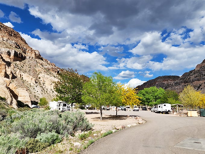 The campground nestled beneath towering canyon walls. RV life with a five-star view that no luxury hotel could possibly match.