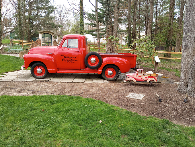 This vintage Village of Columbiana truck with its miniature companion proves that even in gardens, the best things come in pairs.