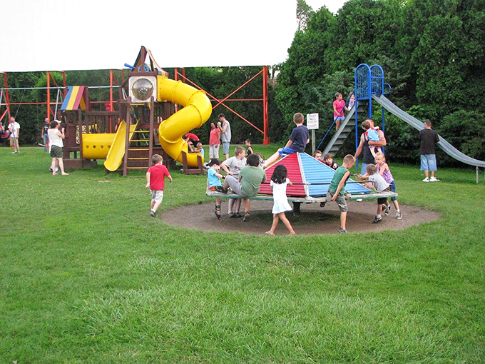Kids burning off pre-movie energy at the playground&mdash;nature's solution to fidgety viewers before the main attraction rolls.