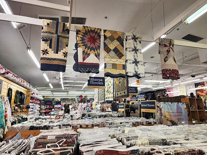 Handcrafted quilts hang like colorful flags of Appalachian tradition, each stitch telling stories that mass-produced bedding could never dream of sharing.