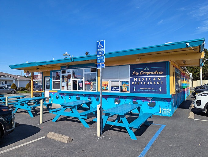 Los Compadres' vibrant blue exterior is like a beacon of flavor. Those picnic tables have hosted countless conversations between locals and visitors discovering authentic Mexican cuisine.