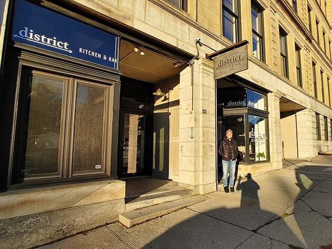 District Kitchen & Bar welcomes diners into exposed brick warmth where contemporary American cuisine meets your retirement budget with open arms.