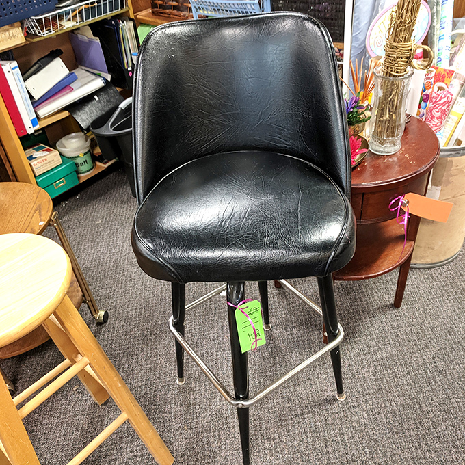 This black vinyl bar stool has stories to tell. Imagine the conversations it could host at your kitchen counter for a fraction of retail price.